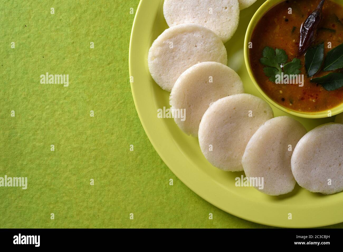 Idli with Sambar in bowl on green background, Indian Dish : south ...