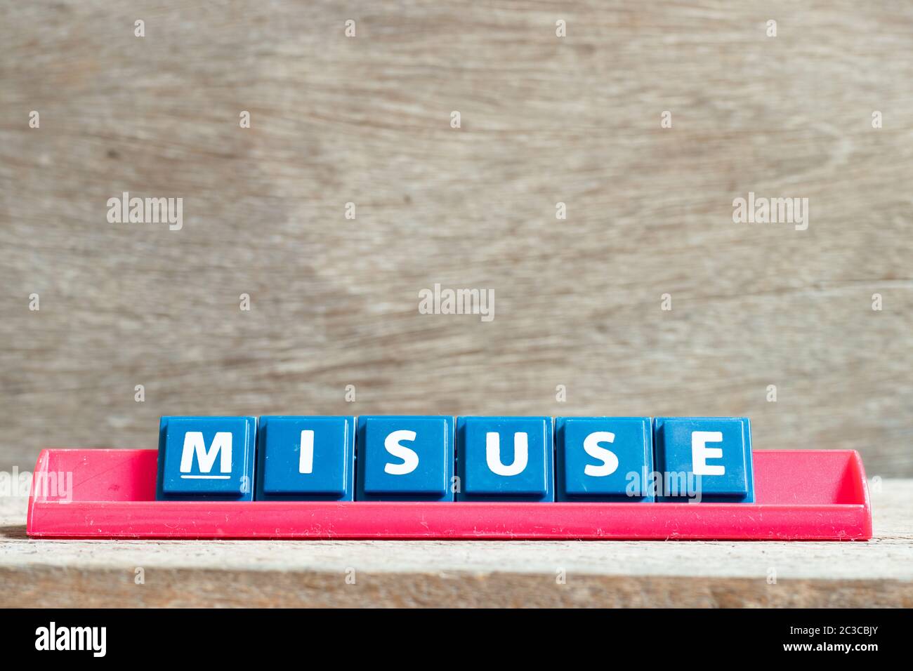 Tile letter on red rack in word misuse on wood background Stock Photo ...