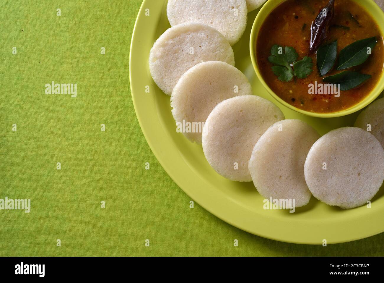 Idli with Sambar in bowl on green background, Indian Dish : south ...