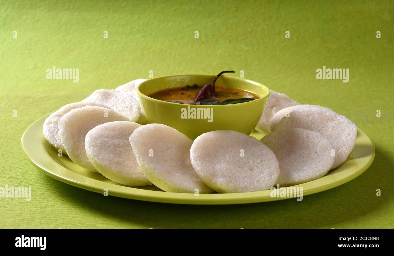 Idli with Sambar in bowl on green background, Indian Dish : south ...
