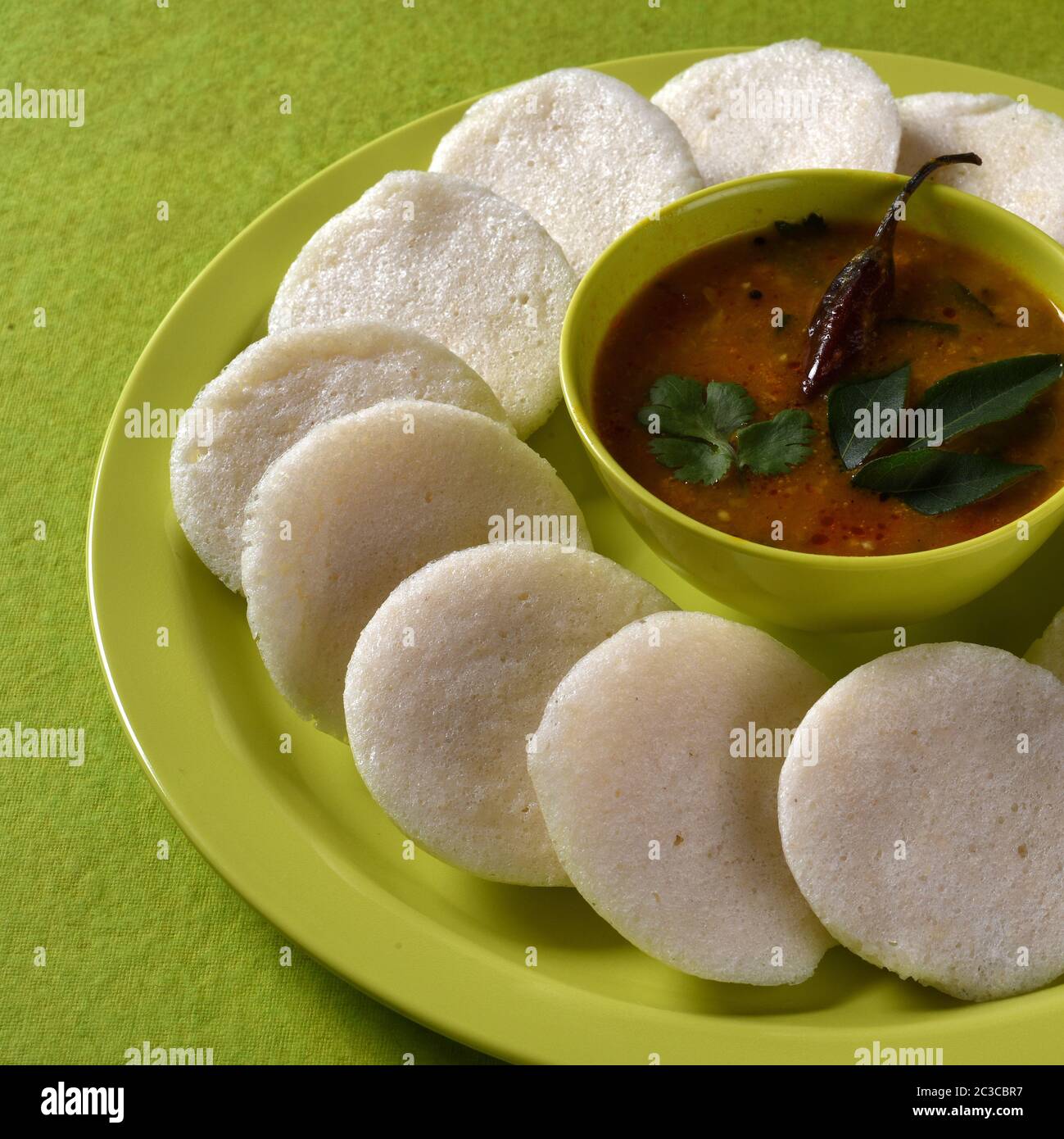 Idli with Sambar in bowl on green background, Indian Dish : south ...