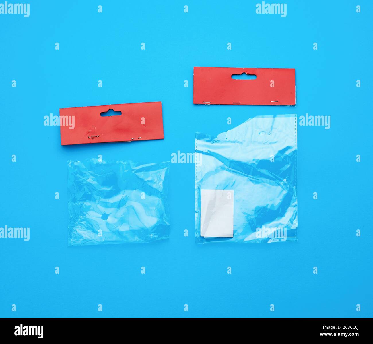 two transparent torn plastic bags with paper red top for packaging ...