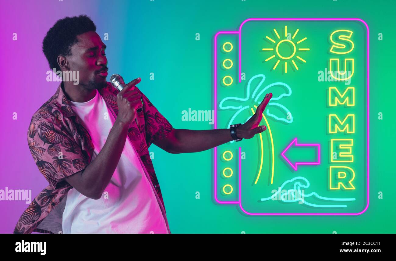 Young musician, party host singing on gradient studio background in ...