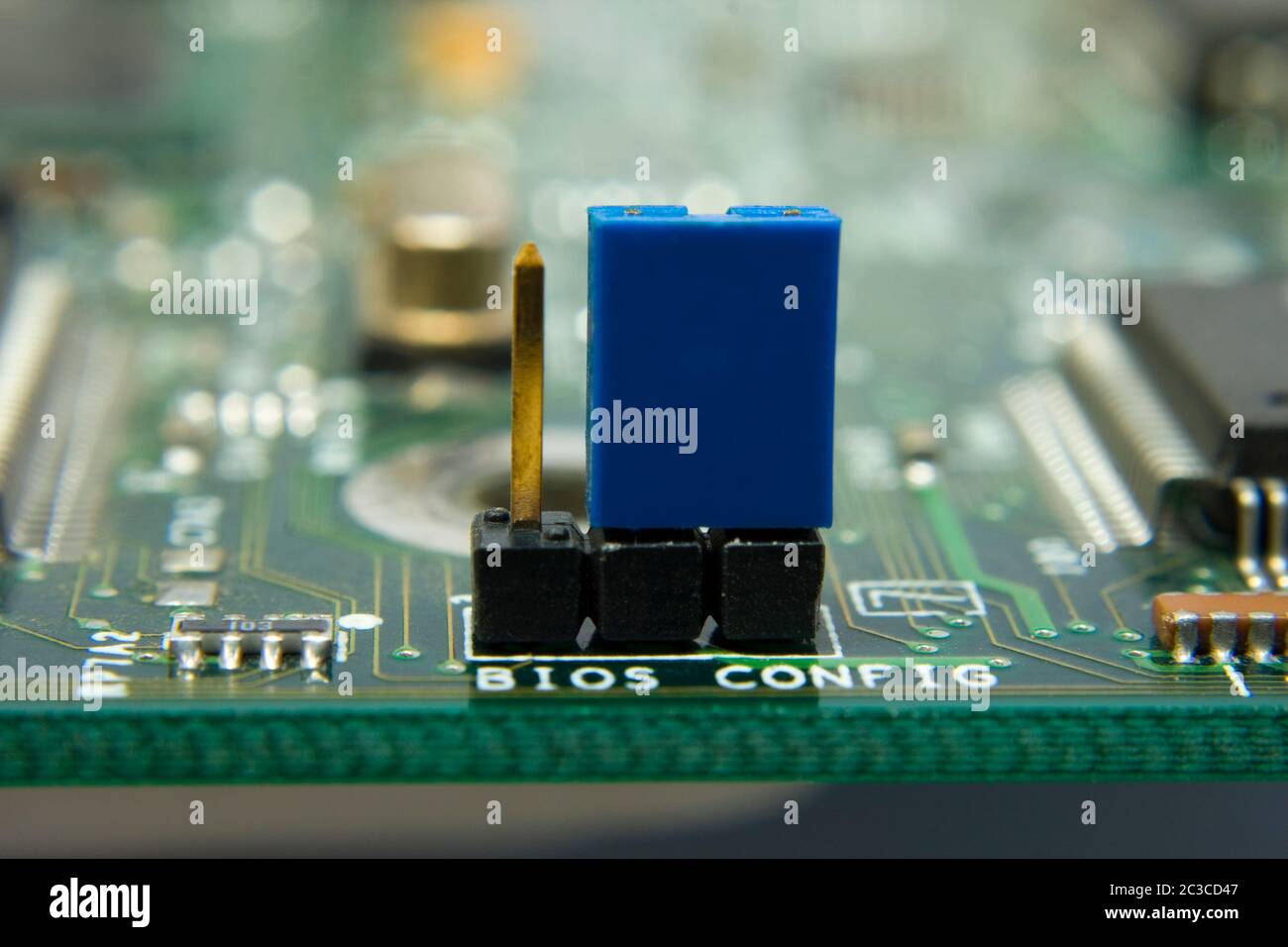 Computer motherboard circuit. Jumper BIOS config in the center Stock ...