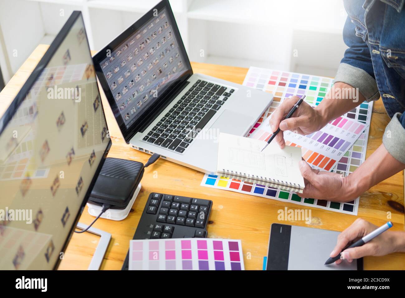 graphic designer team working on web design using color swatches ...