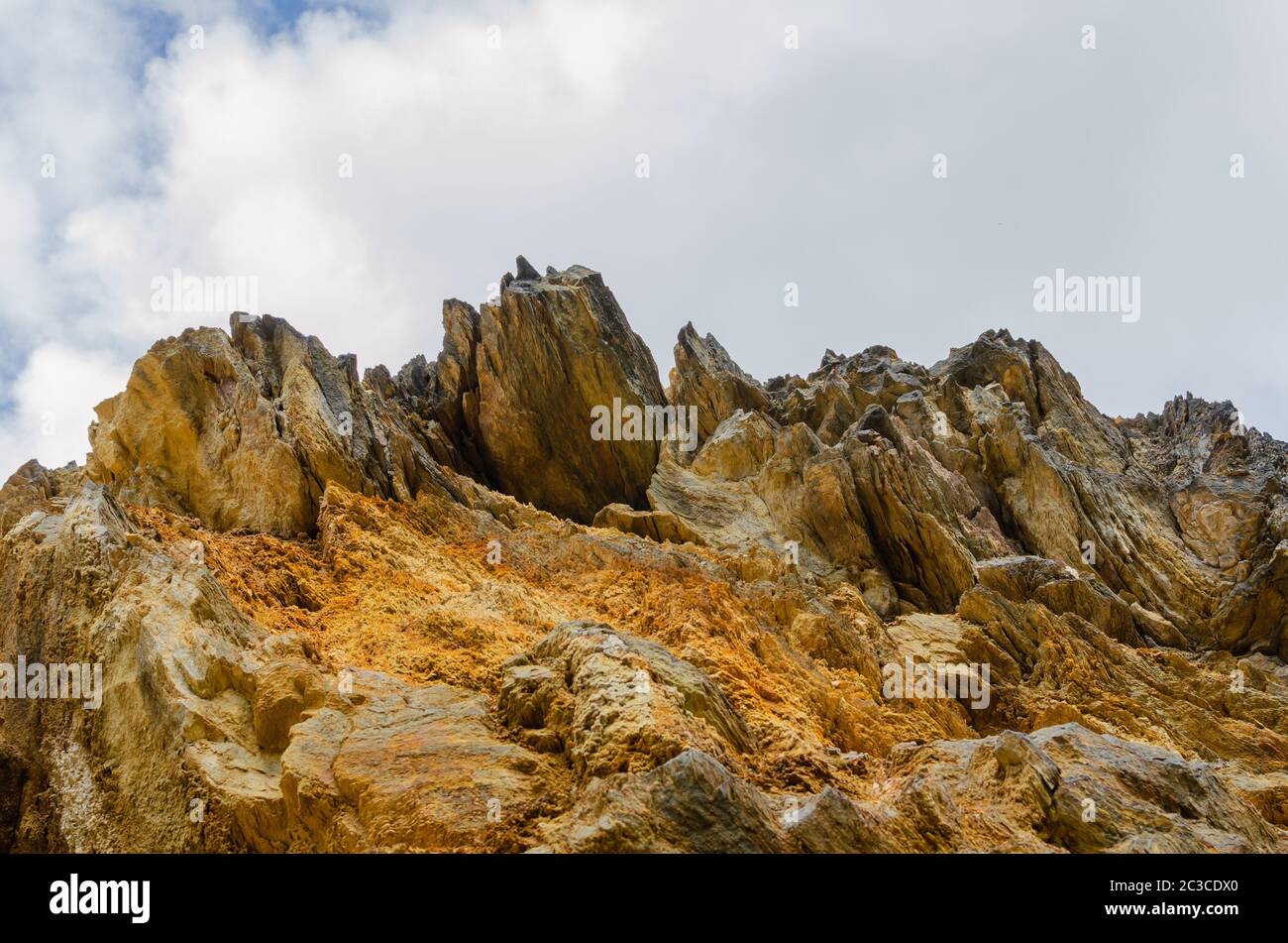 Yellow rock mountain against cloudy sky background. Rock wall in Poland ...