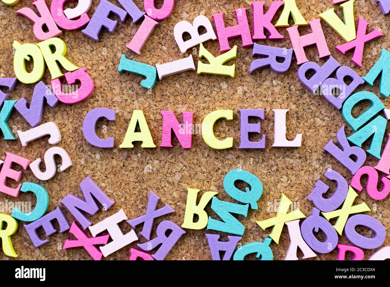 Color alphabet in word cancel with another letter as frame on cork ...