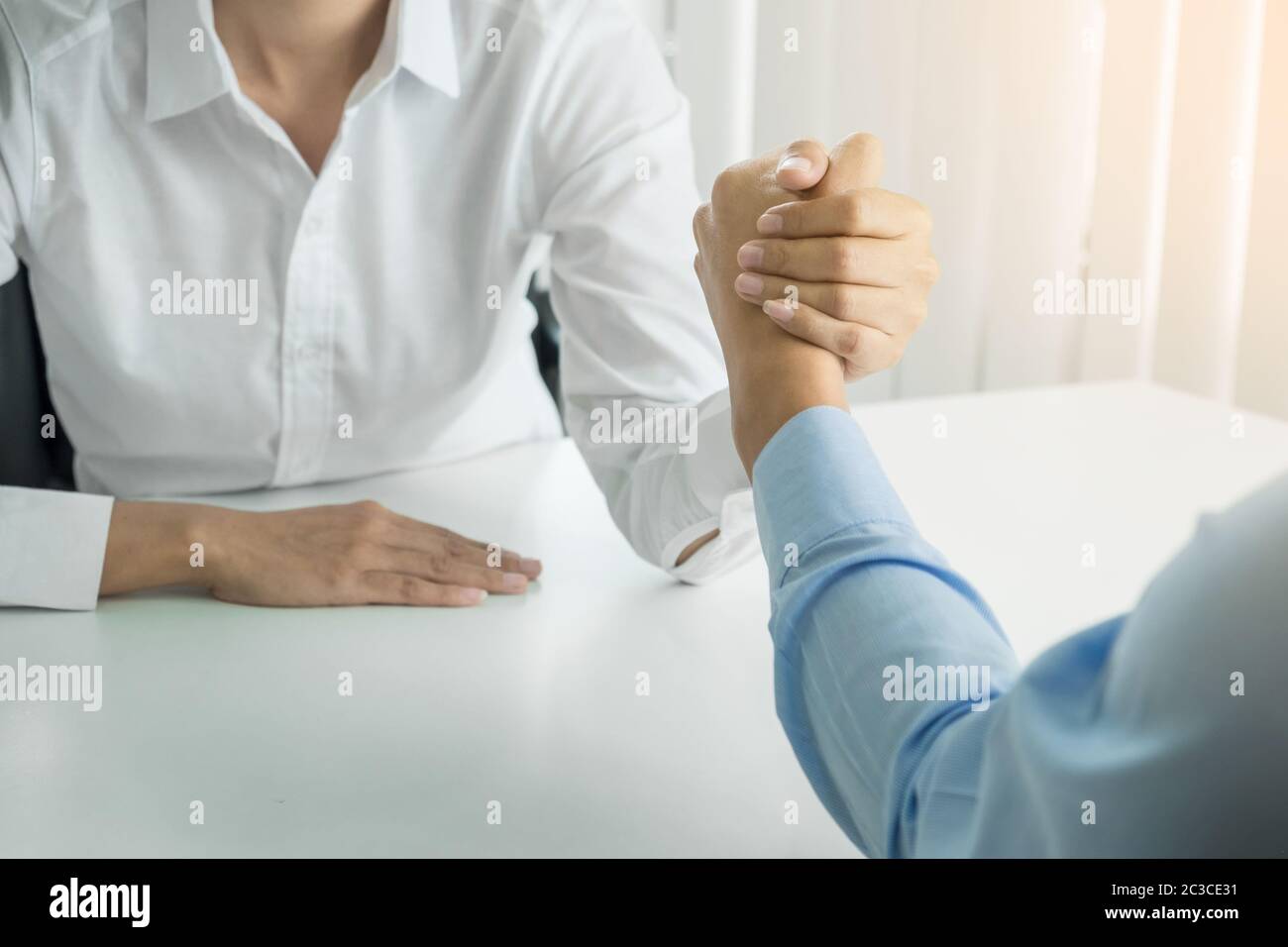 two clasped hands of businessmen Stock Photo - Alamy