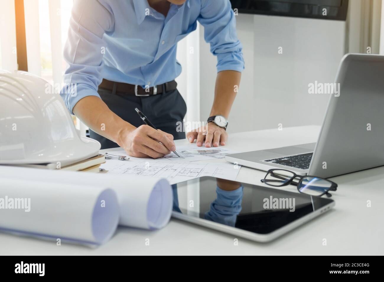 Person's engineer Hand Drawing Plan On Blue Print with architect ...