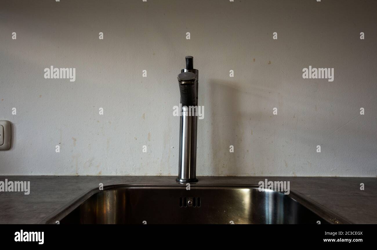 Dirty wall in kitchen with dirty spots behind tap needs cleaning Stock ...