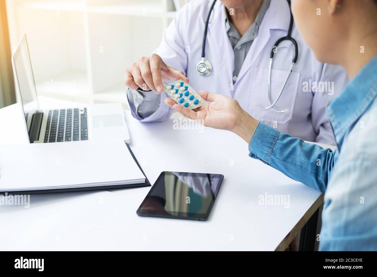 Female doctor hand holding tablet to patient in hospital room Stock ...