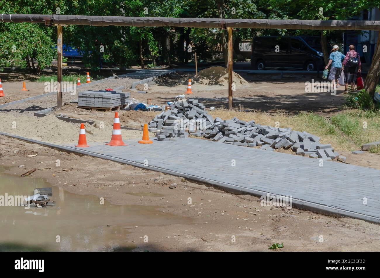 Construction of new sidewalks. Laying paving slabs. The fenced zone of ...