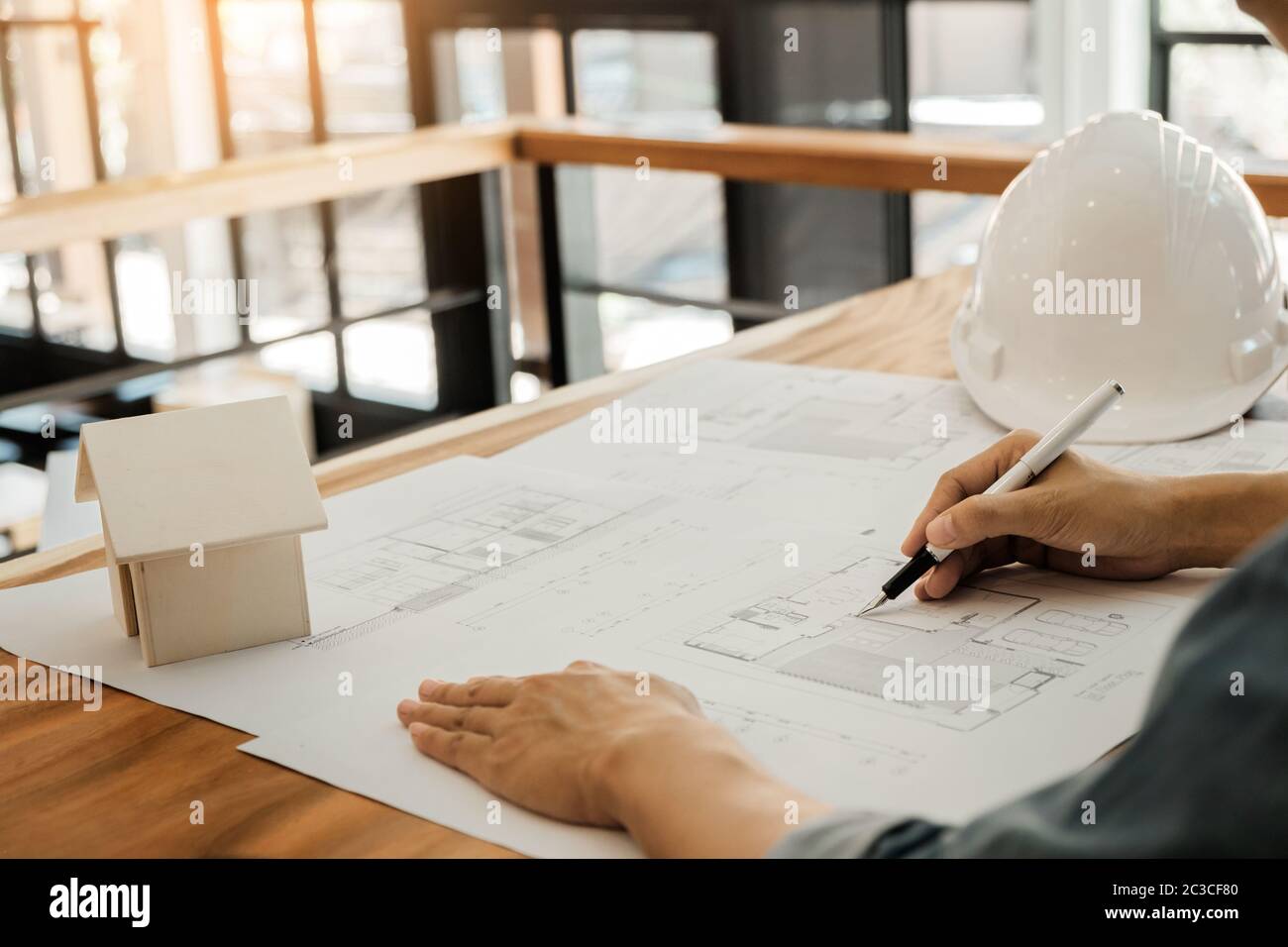 Engineer of architect starting draw a house blueprint on the desk in ...