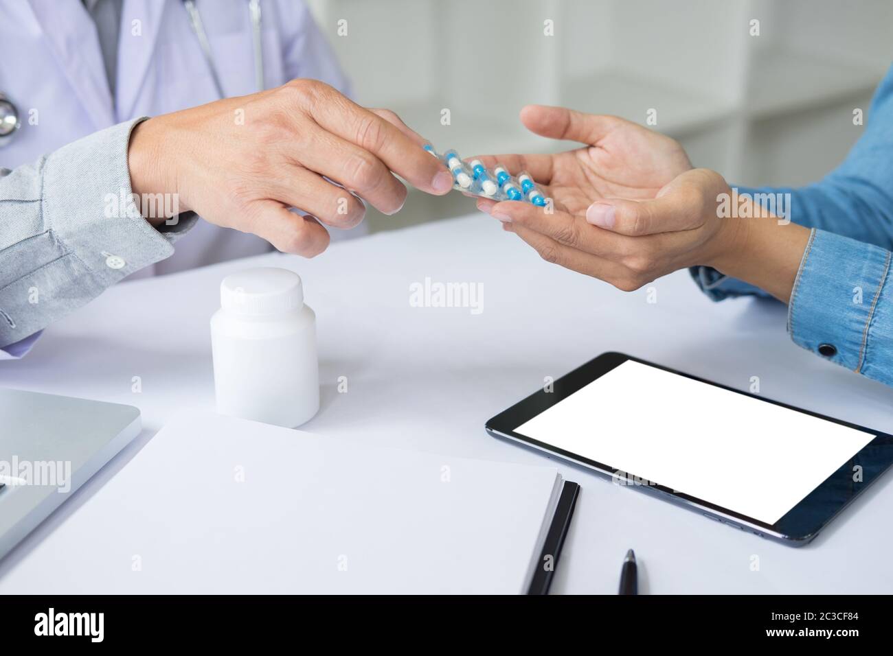 Female doctor hand holding tablet to patient in hospital room Stock ...