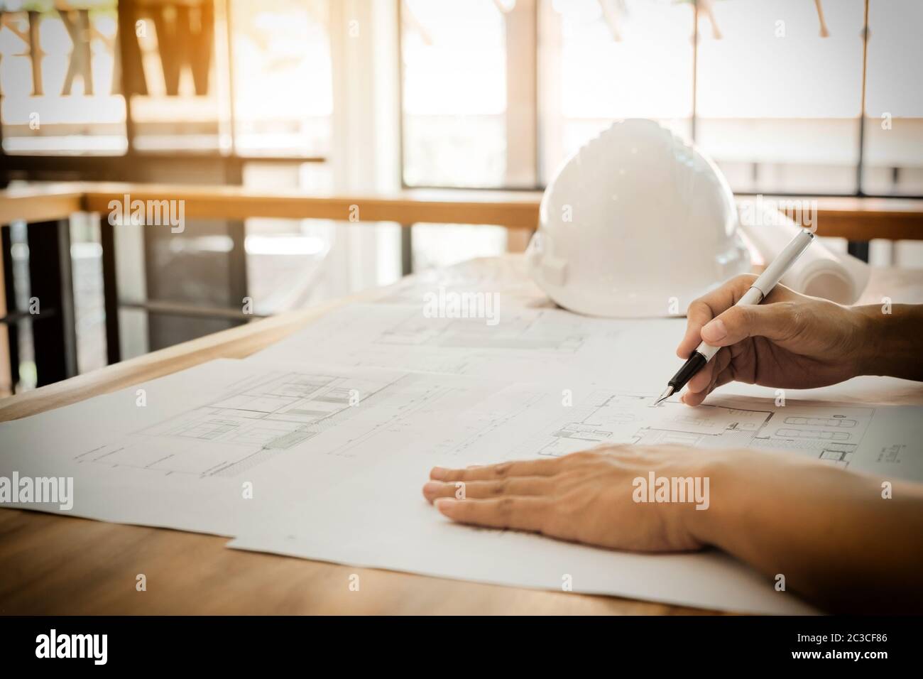 Engineer of architect starting draw a house blueprint on the desk in ...