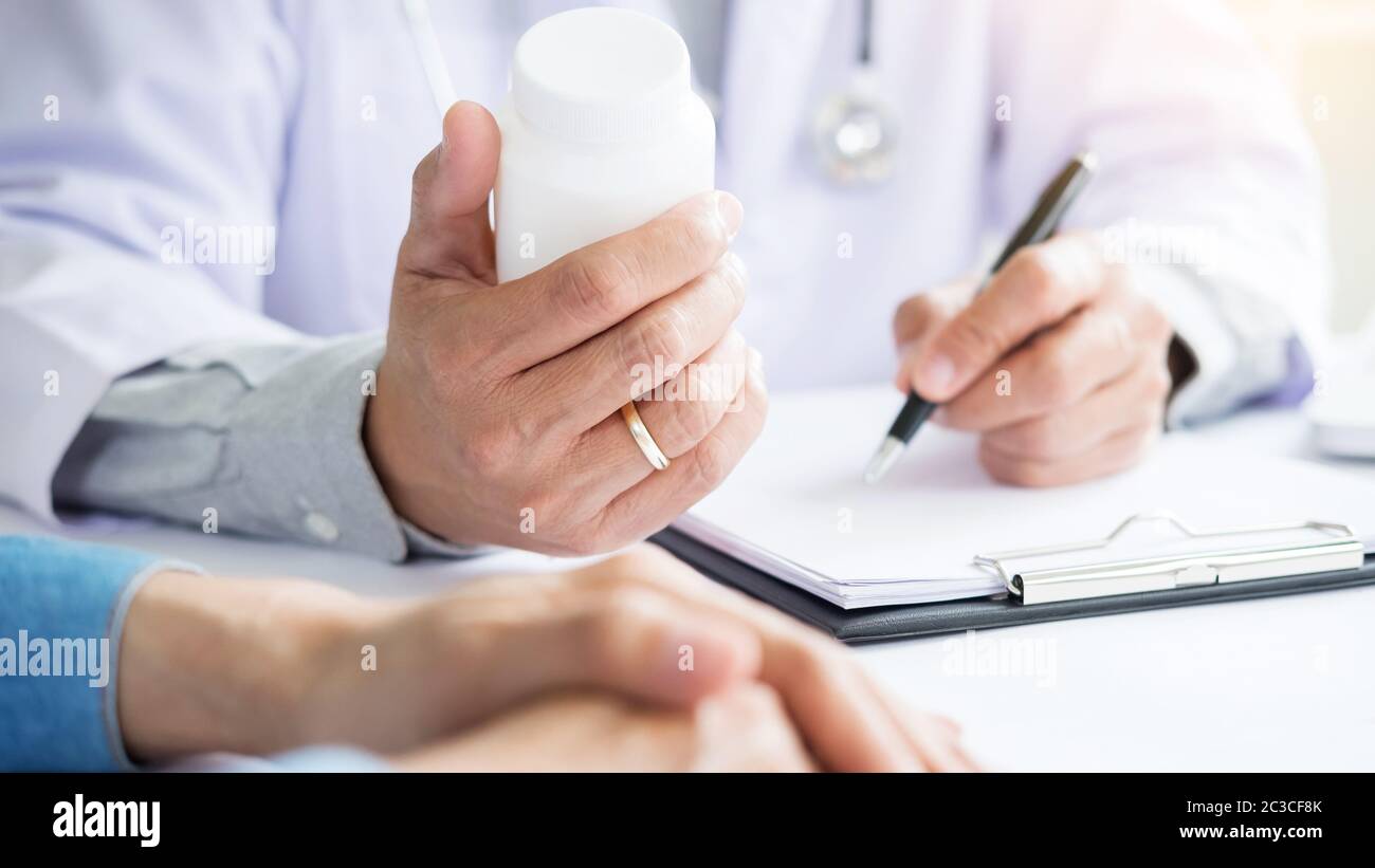 patient listening intently to a male doctor explaining patient symptoms ...