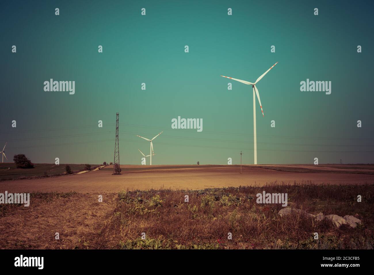 landscape with empty fields and wind turbines over clear blue sky Stock ...
