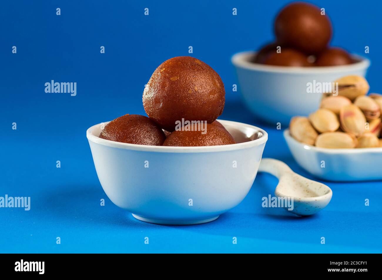 Indian Dessert : Gulab Jamun with Pistachio on blue background Stock ...