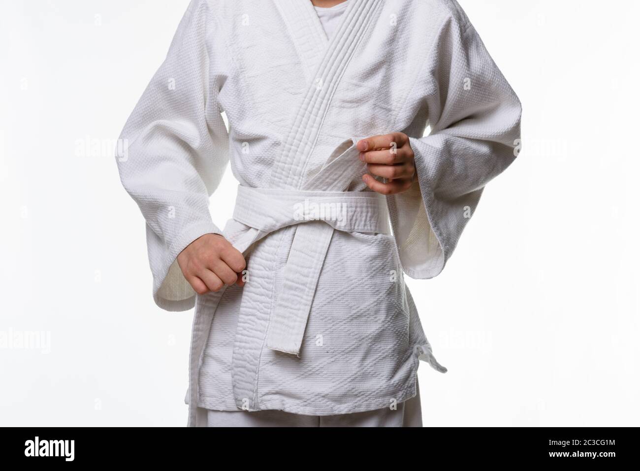 Stages of correct tying of the belt by a teenager on a sports kimono ...