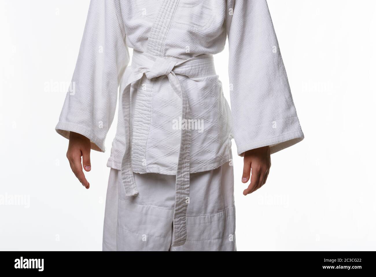 Stages of correct tying of the belt by a teenager on a sports kimono ...