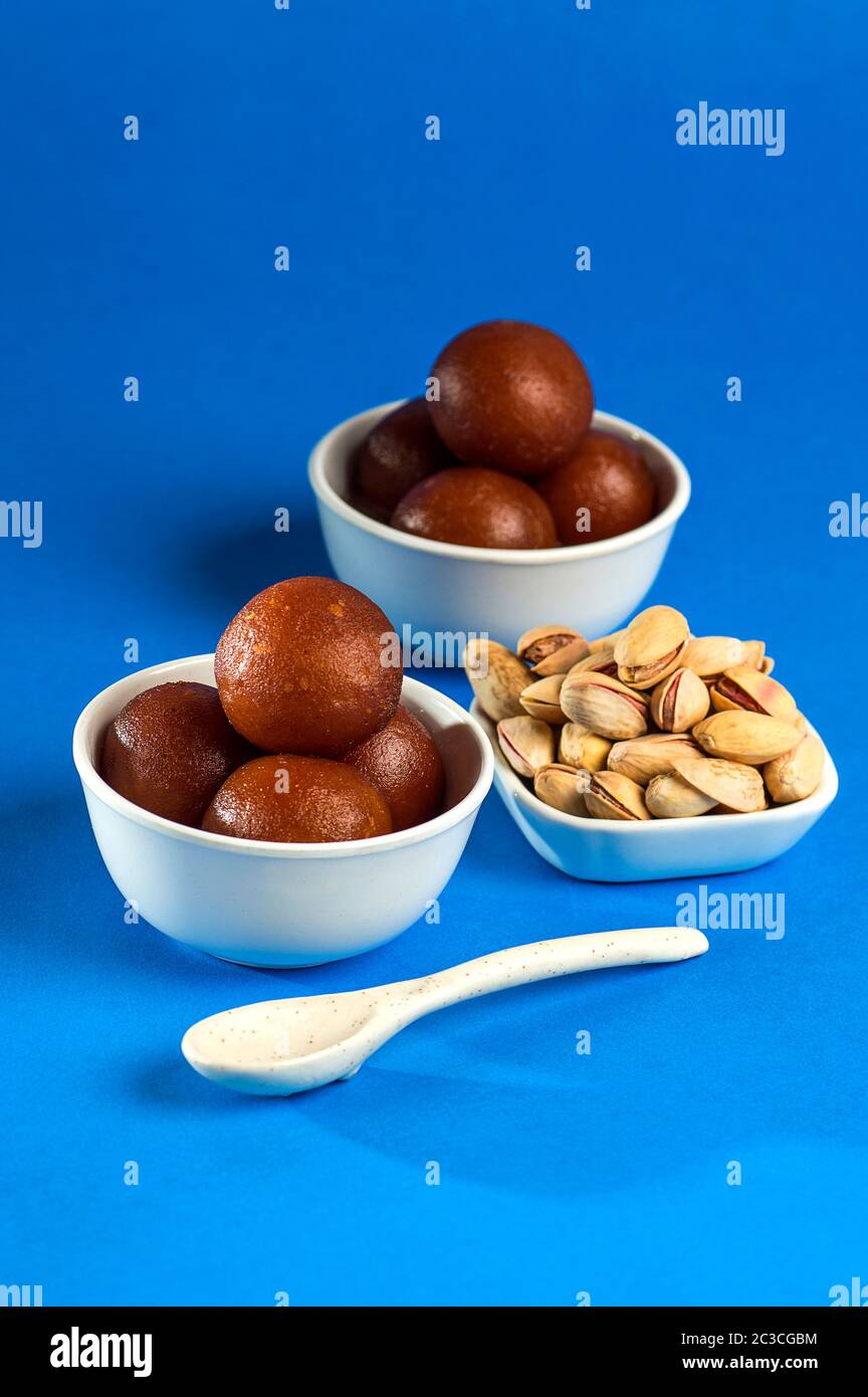 Indian Dessert : Gulab Jamun with Pistachio on blue background Stock ...