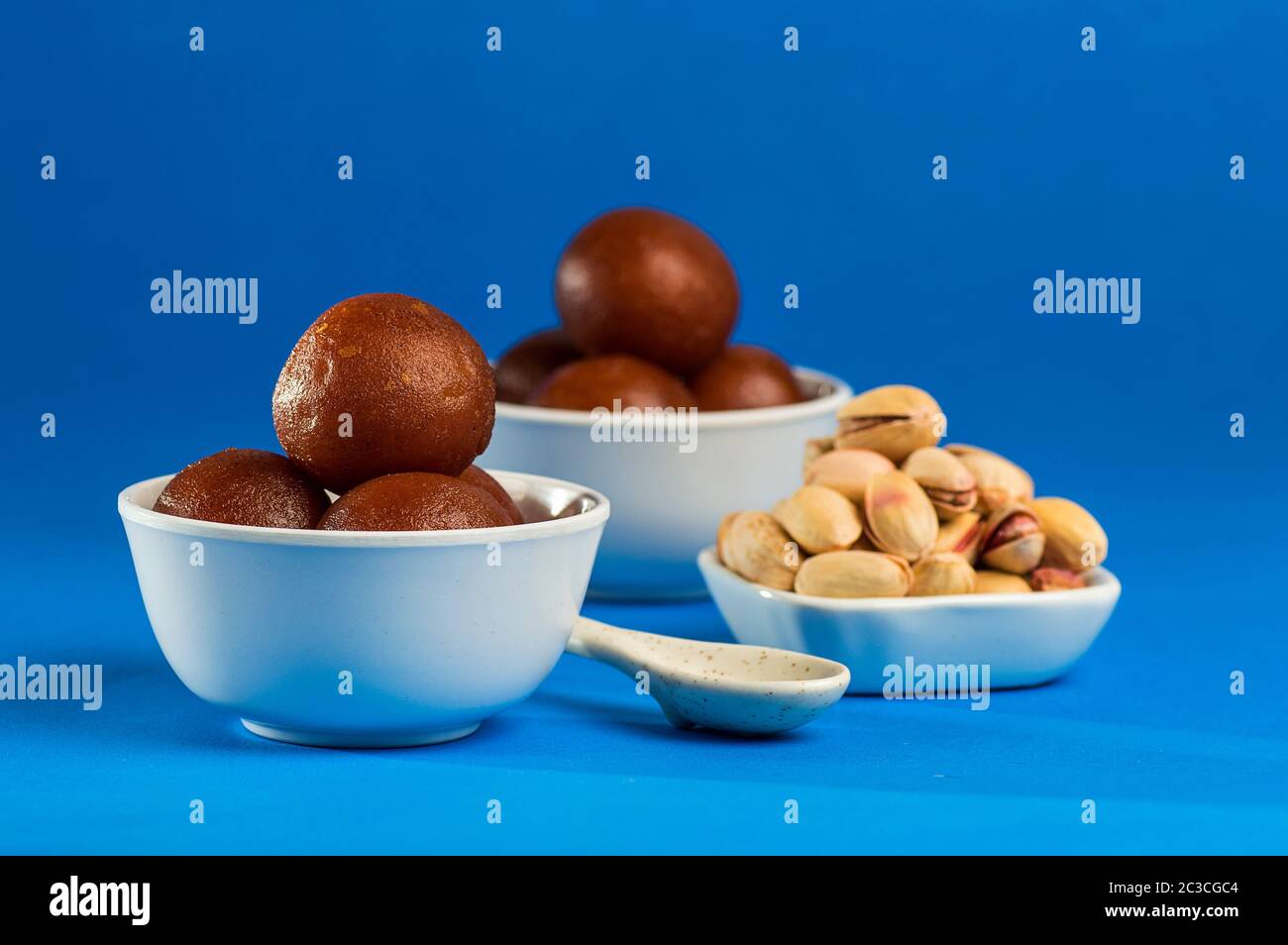 Indian Dessert : Gulab Jamun with Pistachio on blue background Stock ...