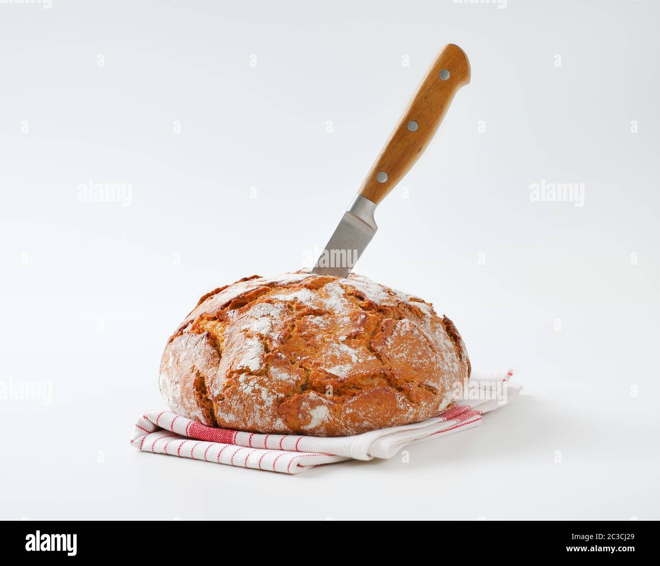 Loaf of rustic bread with a knife stuck in it Stock Photo - Alamy