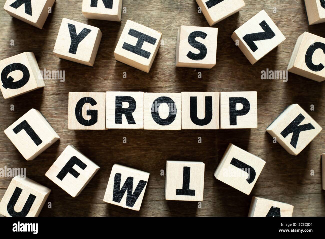 Letter block in word group with another block on wood background Stock ...