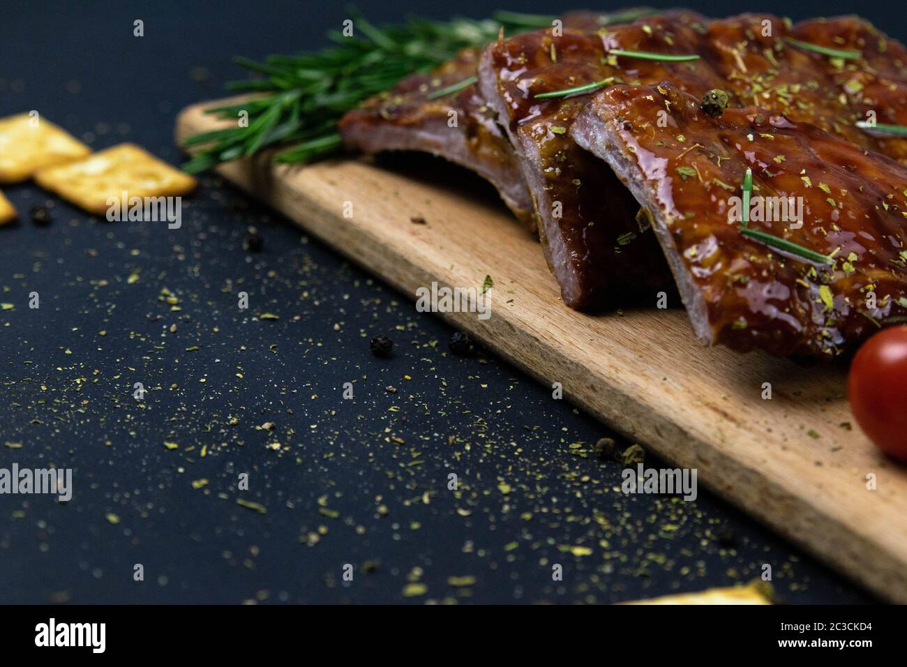 Barbecue Pork Spare Ribs as side view with basil and tomatoes and hot ...