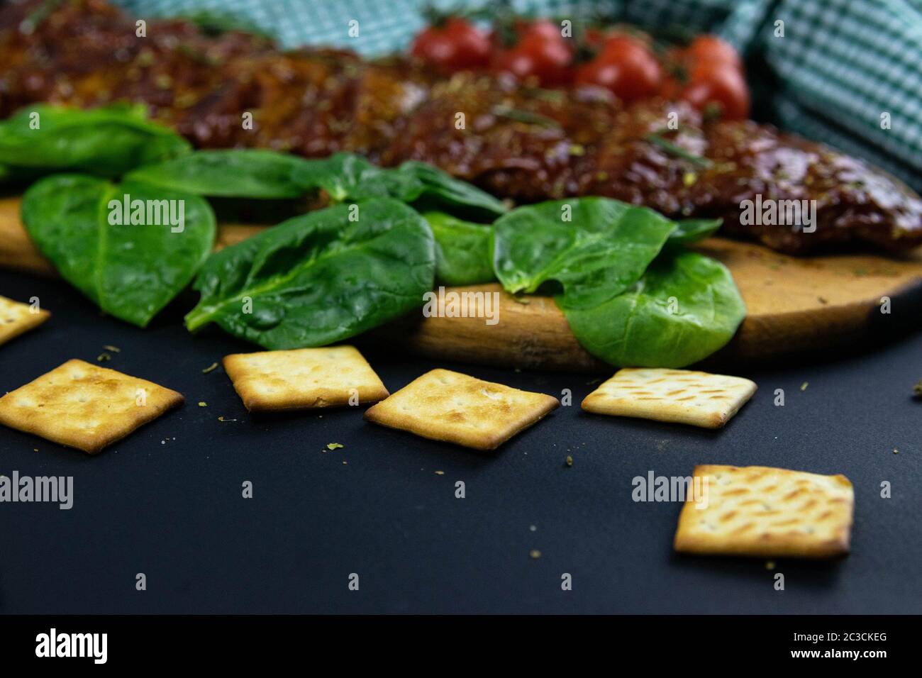 Barbecue Pork Spare Ribs as side view with basil and tomatoes and hot ...