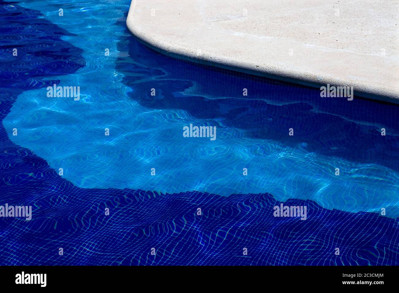 swimming pool blue water detail in summer time Stock Photo - Alamy