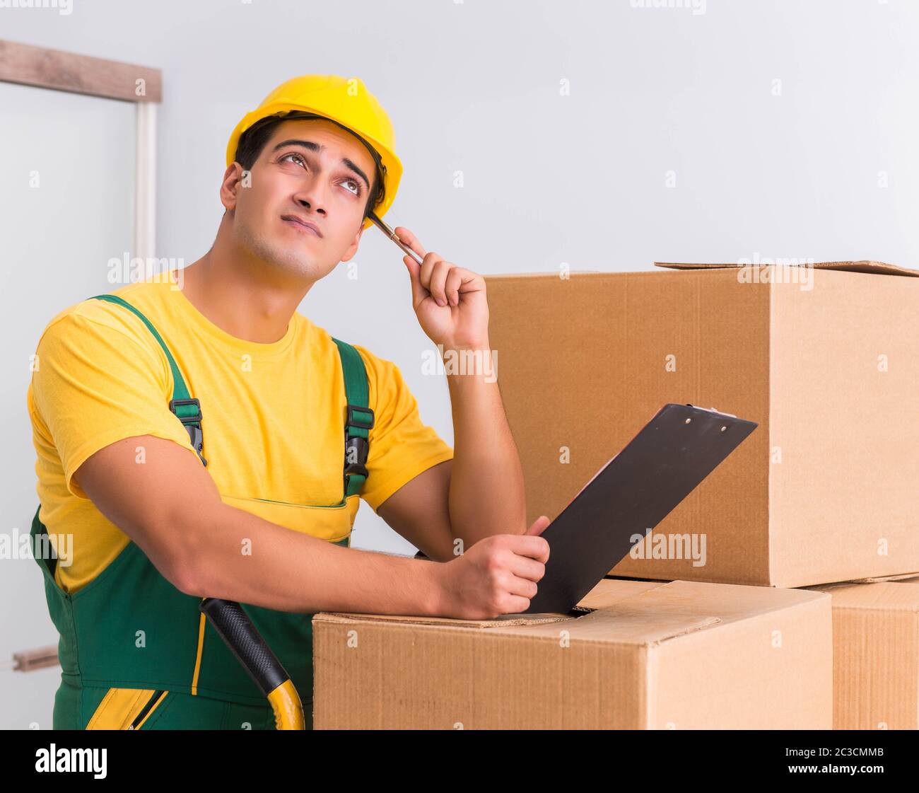 Transportation worker delivering boxes to house Stock Photo - Alamy