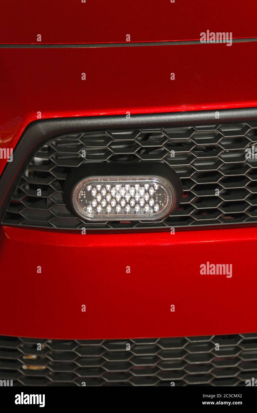 LED lights at red car grille Stock Photo - Alamy