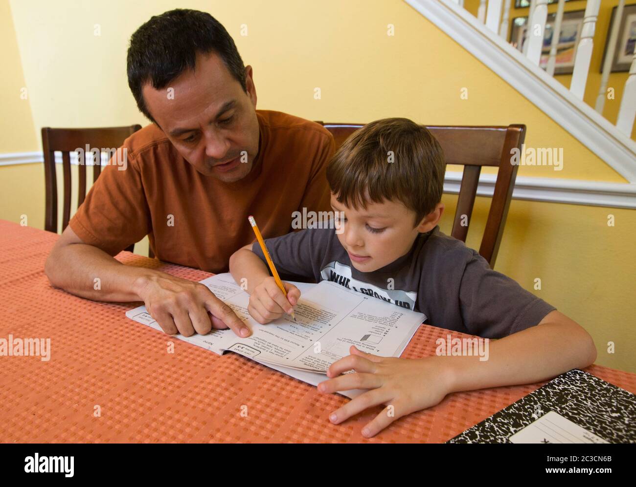Mexican-American father ( 50 year old) helps out his Hispanic 7 year ...