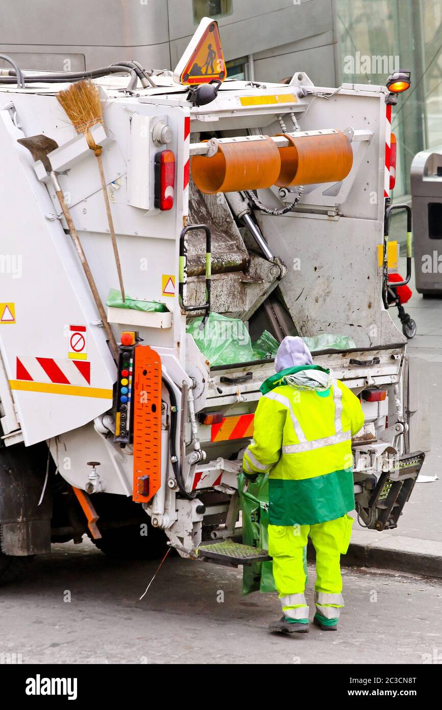 Garbage man at work at dump truck Stock Photo - Alamy