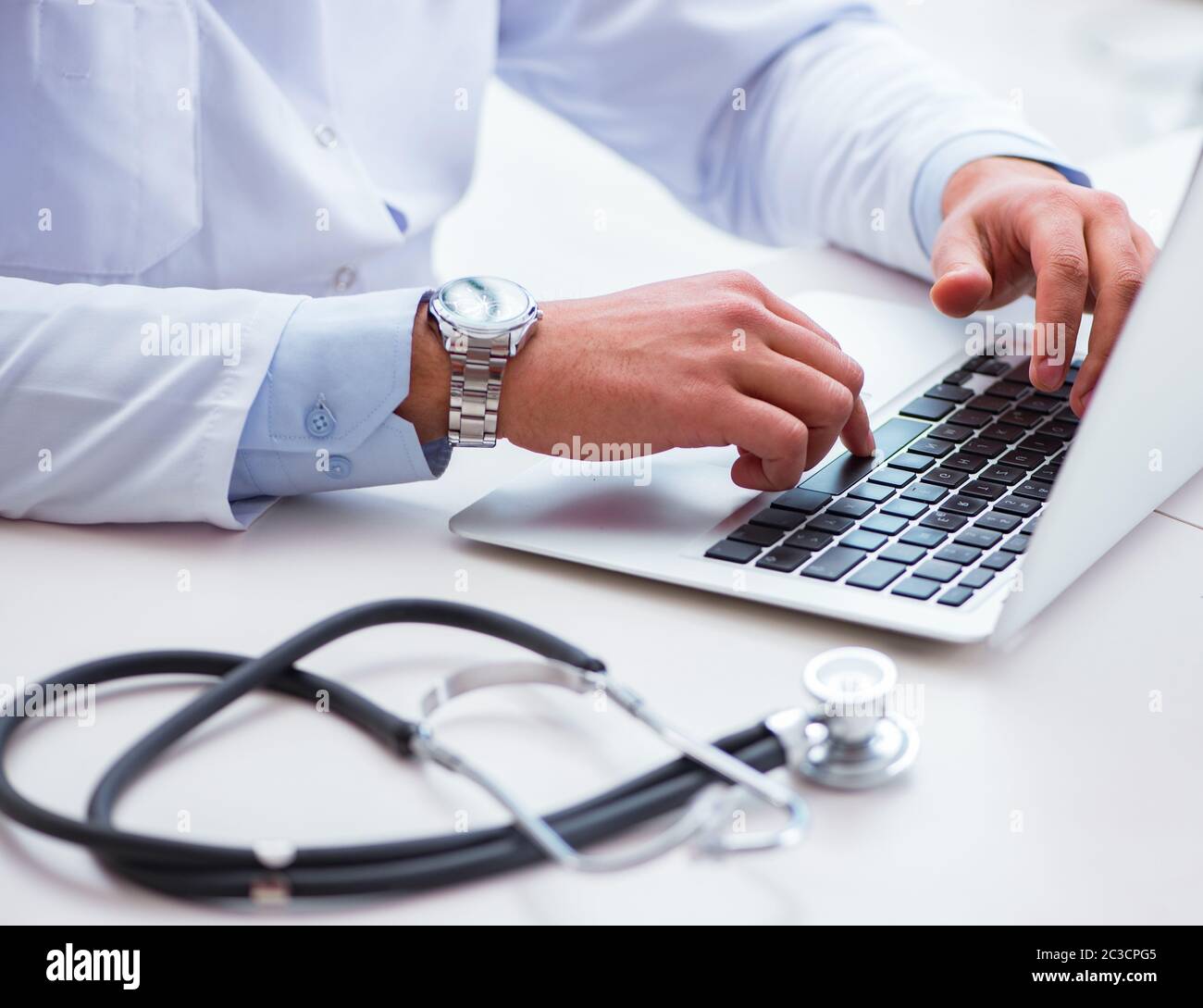 Doctor working on the computer Stock Photo - Alamy