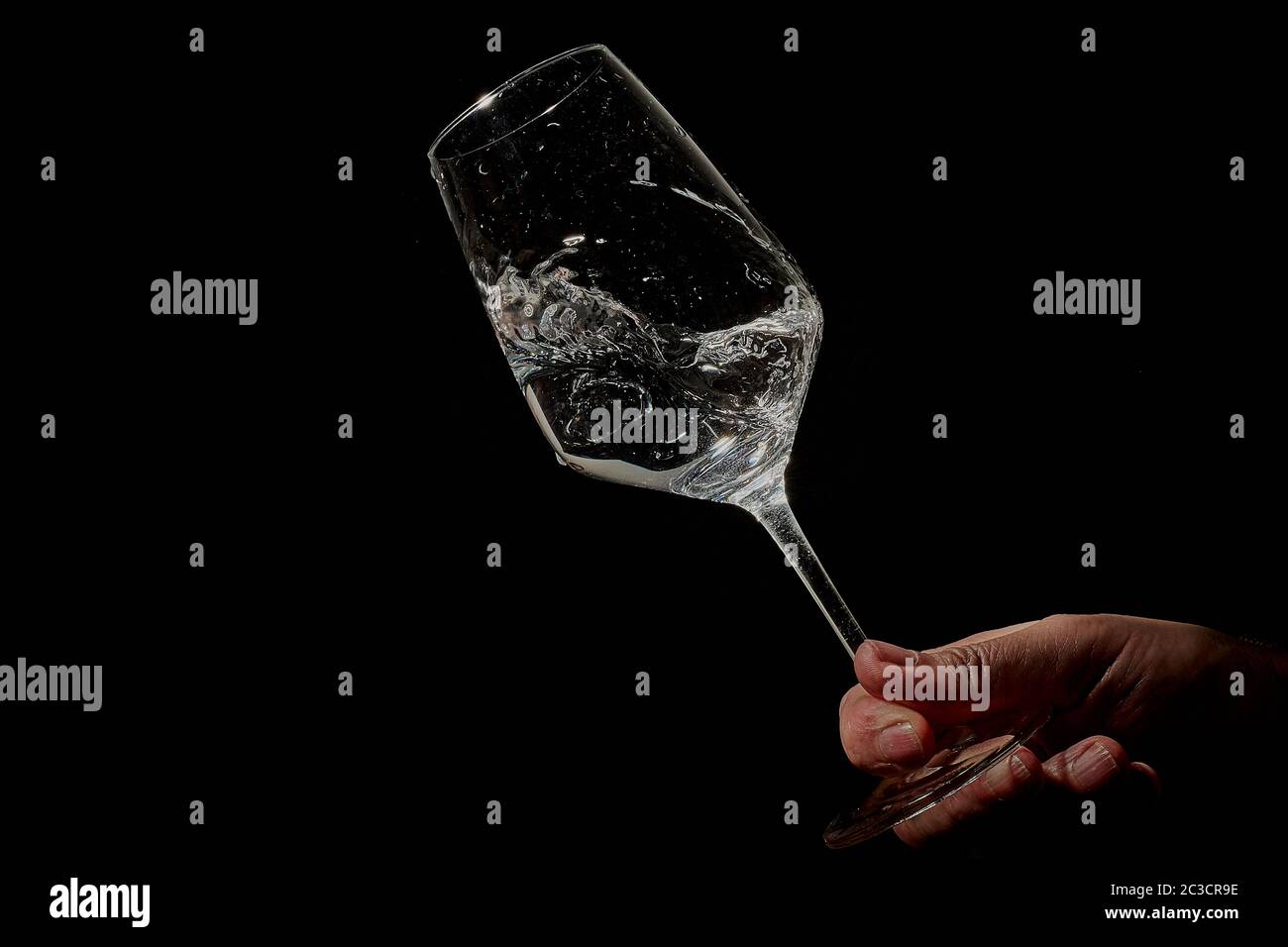 spilling clear water from a wine glass Stock Photo - Alamy