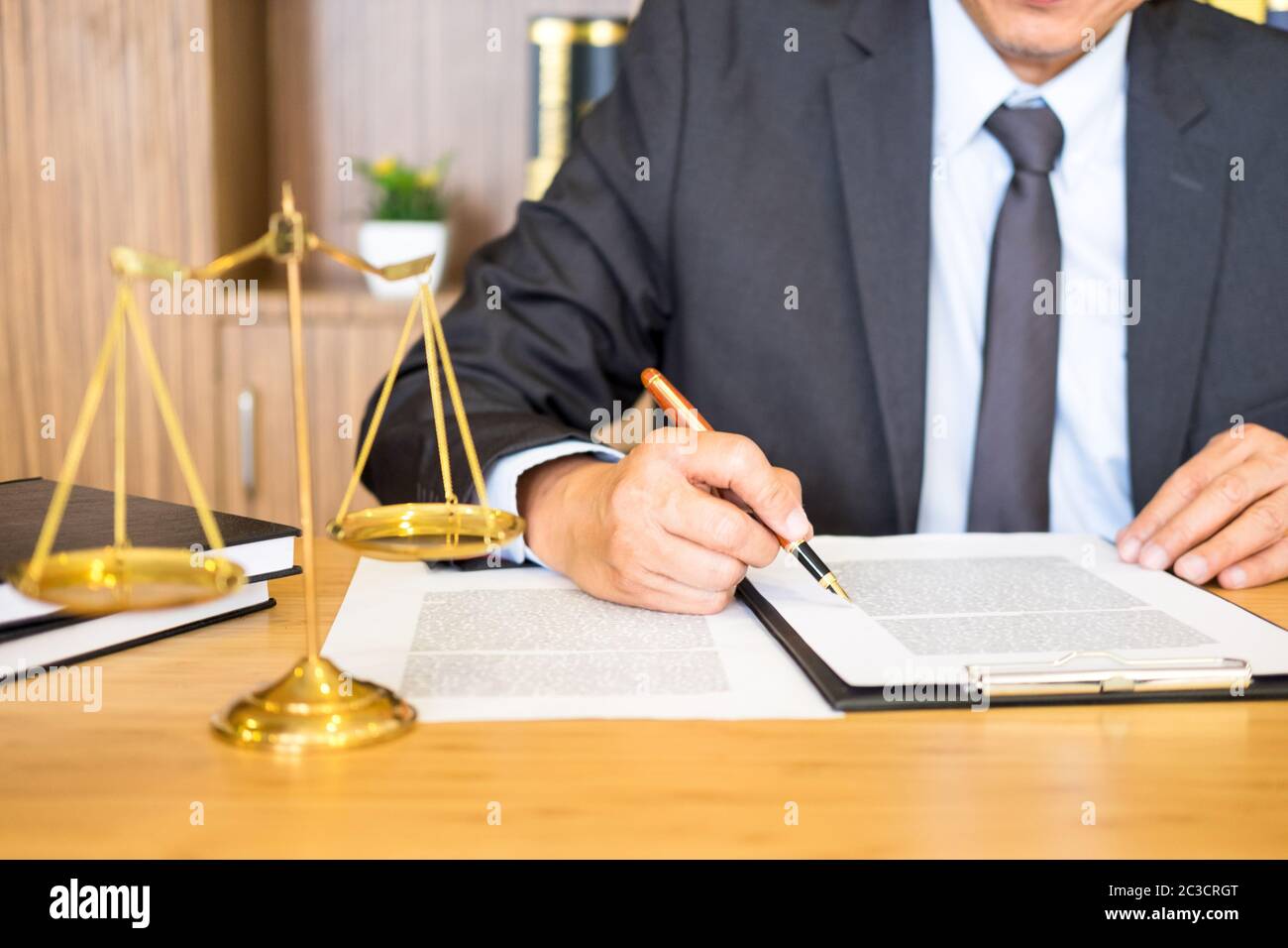 lawyer judge reading documents at desk in courtroom working on wooden ...