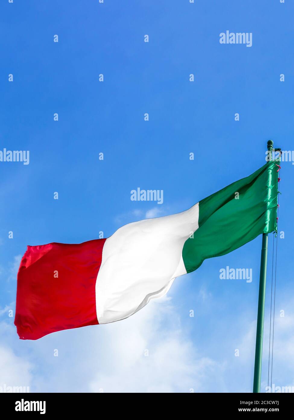 Waving Italian flag against blue sky Stock Photo - Alamy