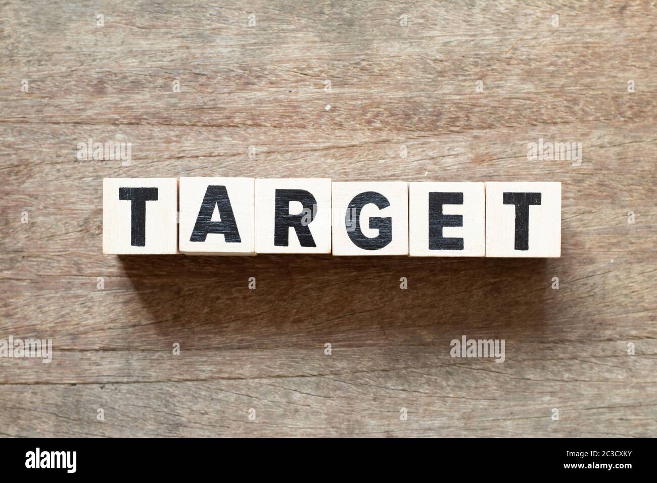 Letter block in word target on wood background Stock Photo - Alamy