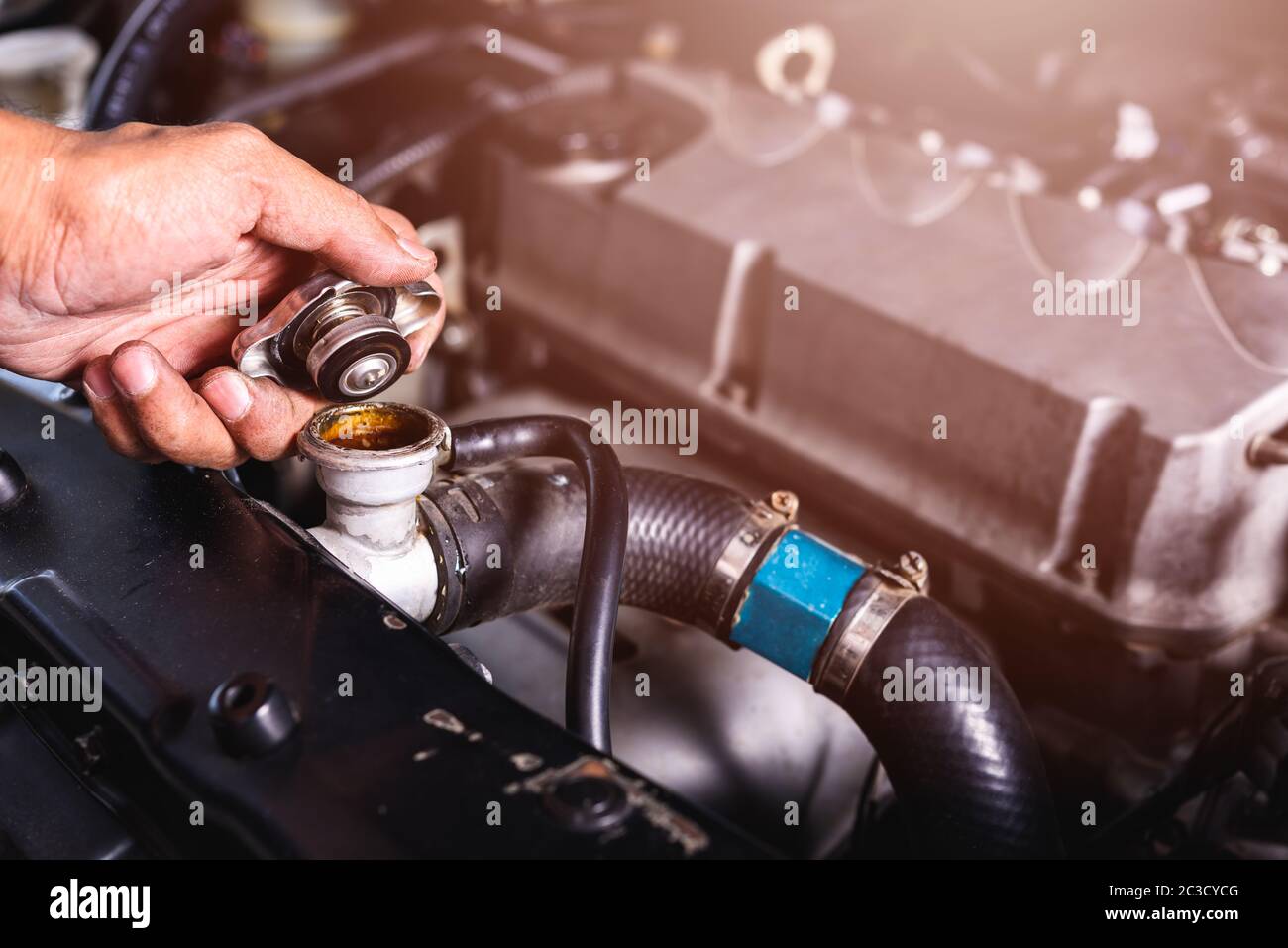 Hand of auto mechanic technician service check cooling water he open ...