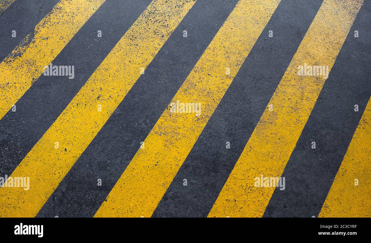 Yellow and back striped texture useful as a background Stock Photo - Alamy