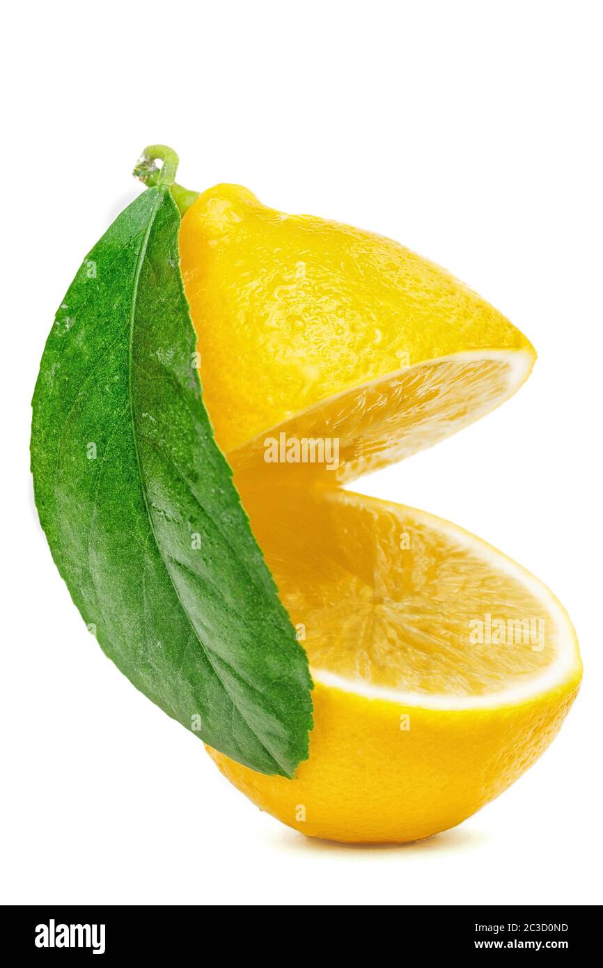 lemon cut into two parts with a leaf isolated on a white background ...