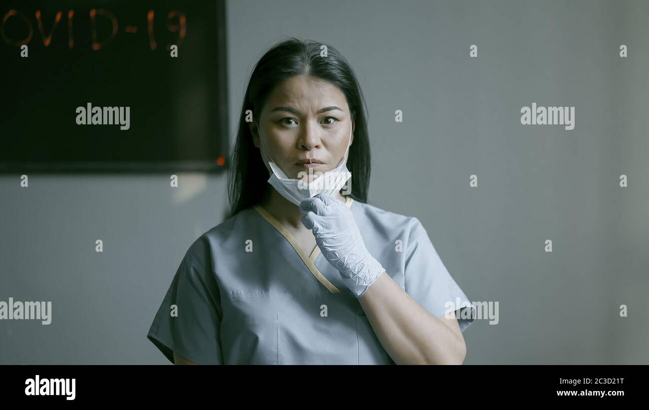 Beautiful Asian woman opened her face by removing her face mask and ...