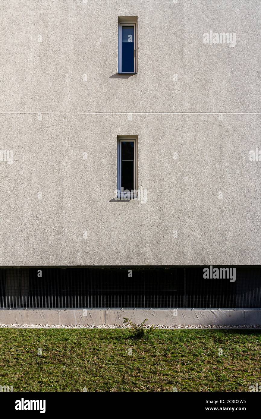 Modern wall with some windows and a grass. Architectural detail ...