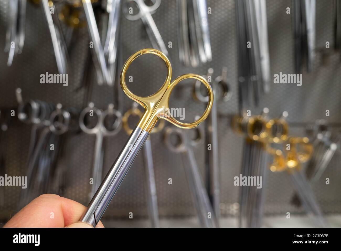 pair of surgical scissors is taken out of the cabinet in a ...