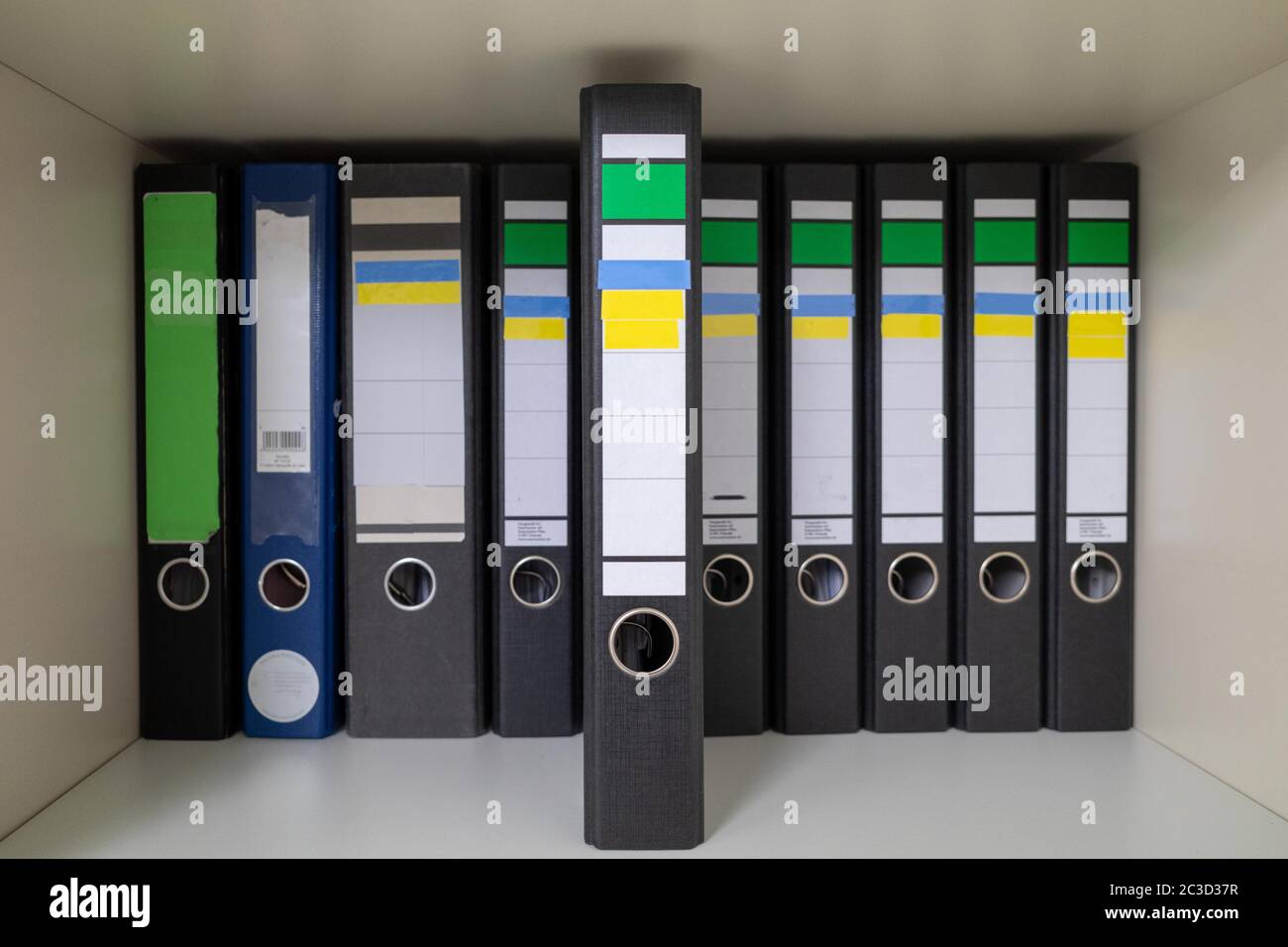 a file is taken out of a closet with many files Stock Photo - Alamy