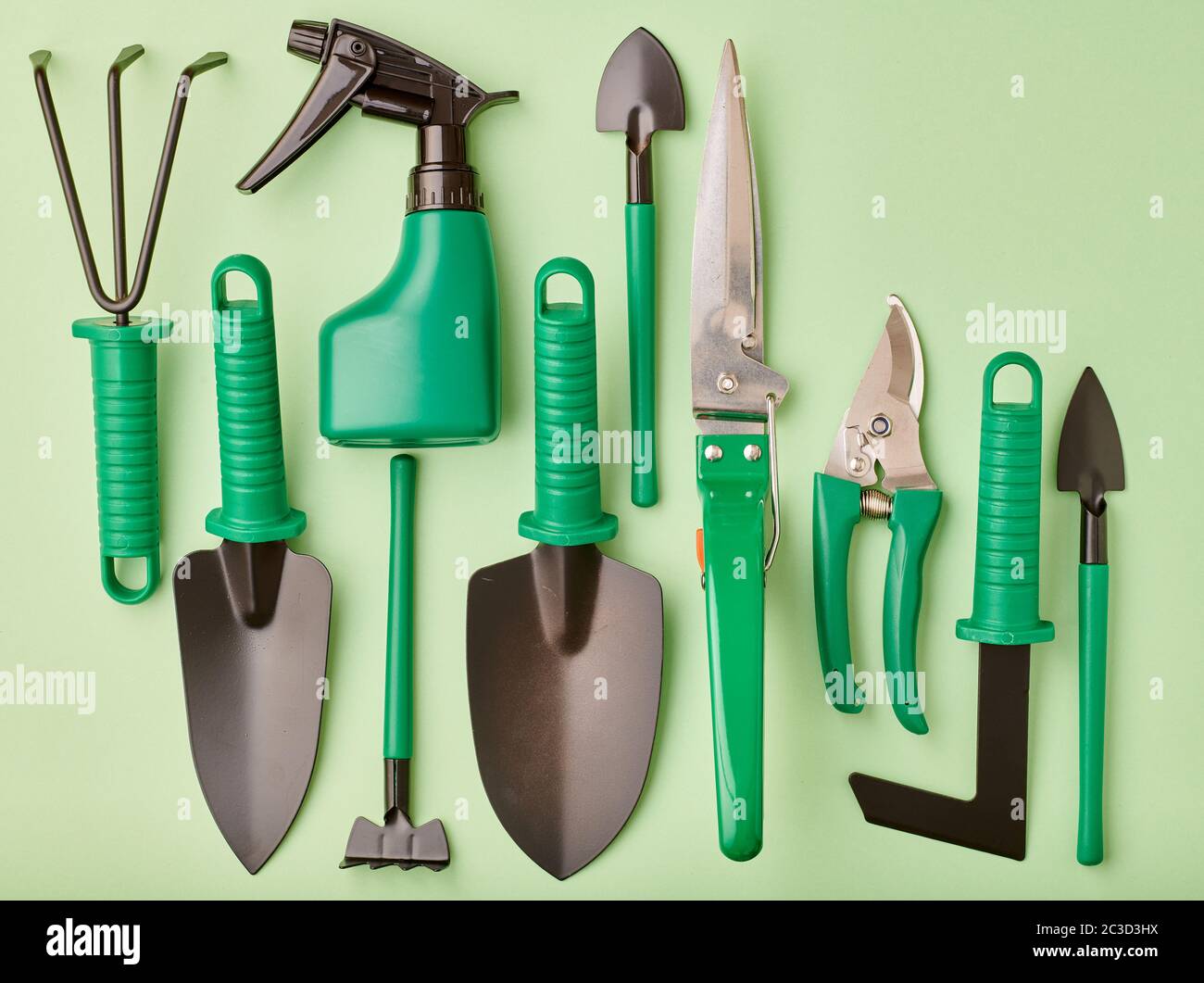 Gardening tools on green background flat lay Stock Photo - Alamy