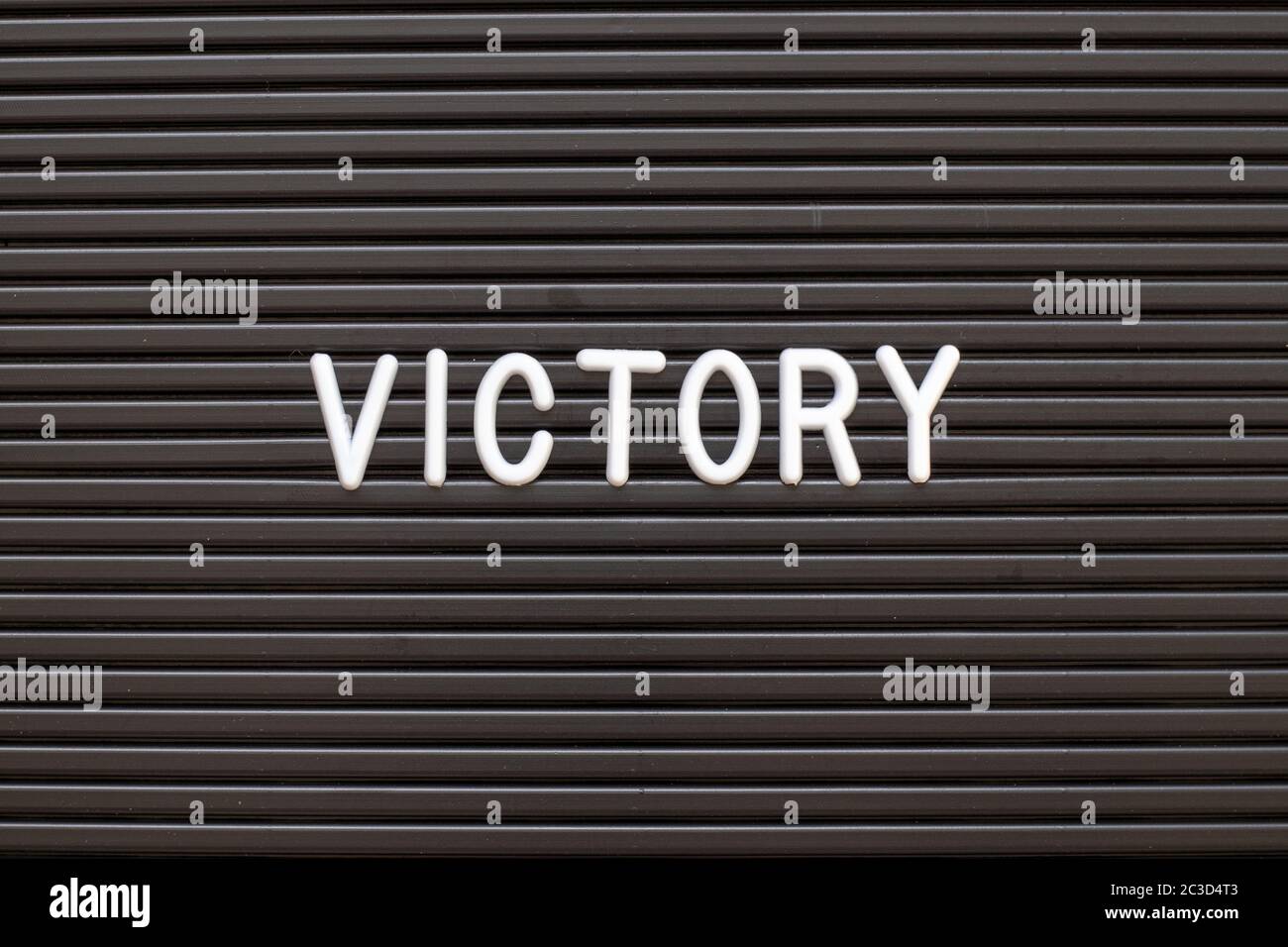 Black color felt letter board with white alphabet in word victory ...