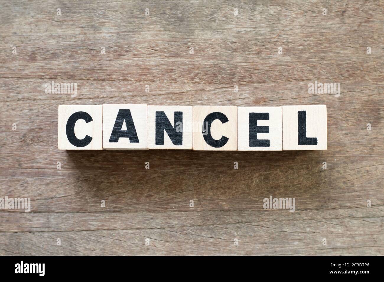 Letter block in word cancel on wood background Stock Photo - Alamy